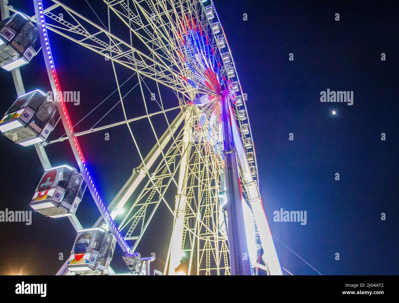 Ferris wheel and moon in the blue sky at Place de la Concorde in Paris ...