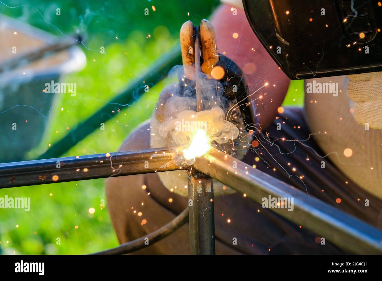 A bright flash of an electric arc between the electrode and the metal ...