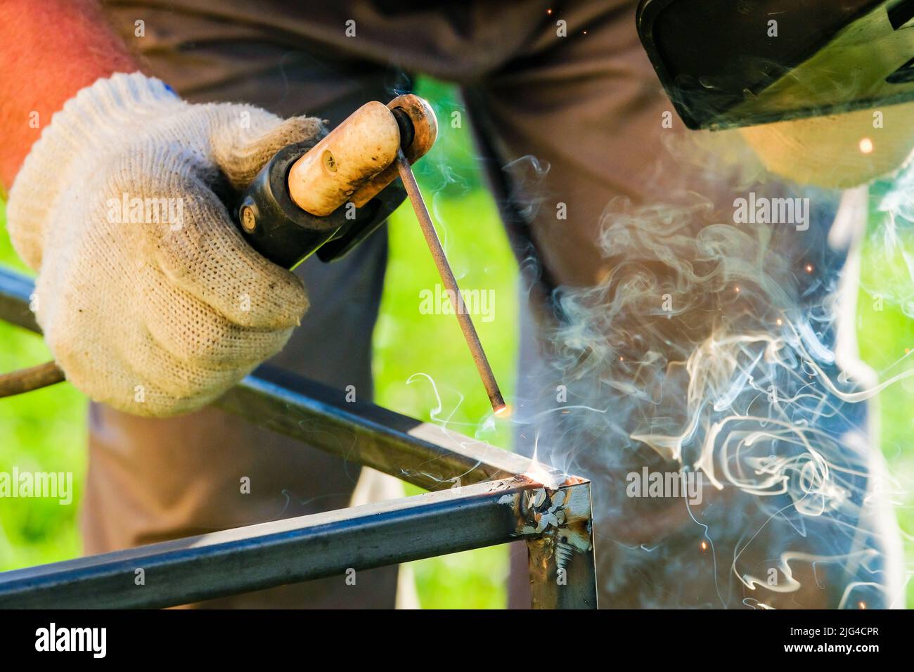 Selective focus on the red hot tip of an arc welding electrode. Welding ...