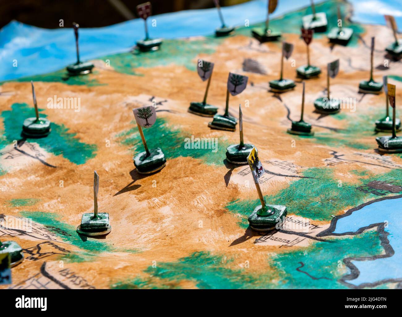 reproduction of an ancient medieval map with flags to mark the war ...