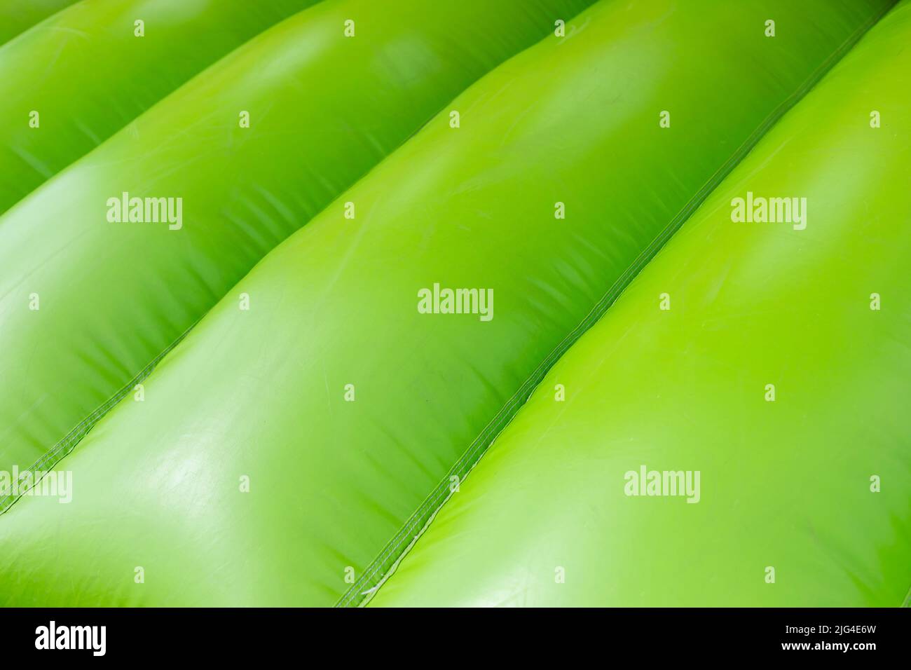 Green inflatable trampoline. Obstacle course. Details of amusement park ...