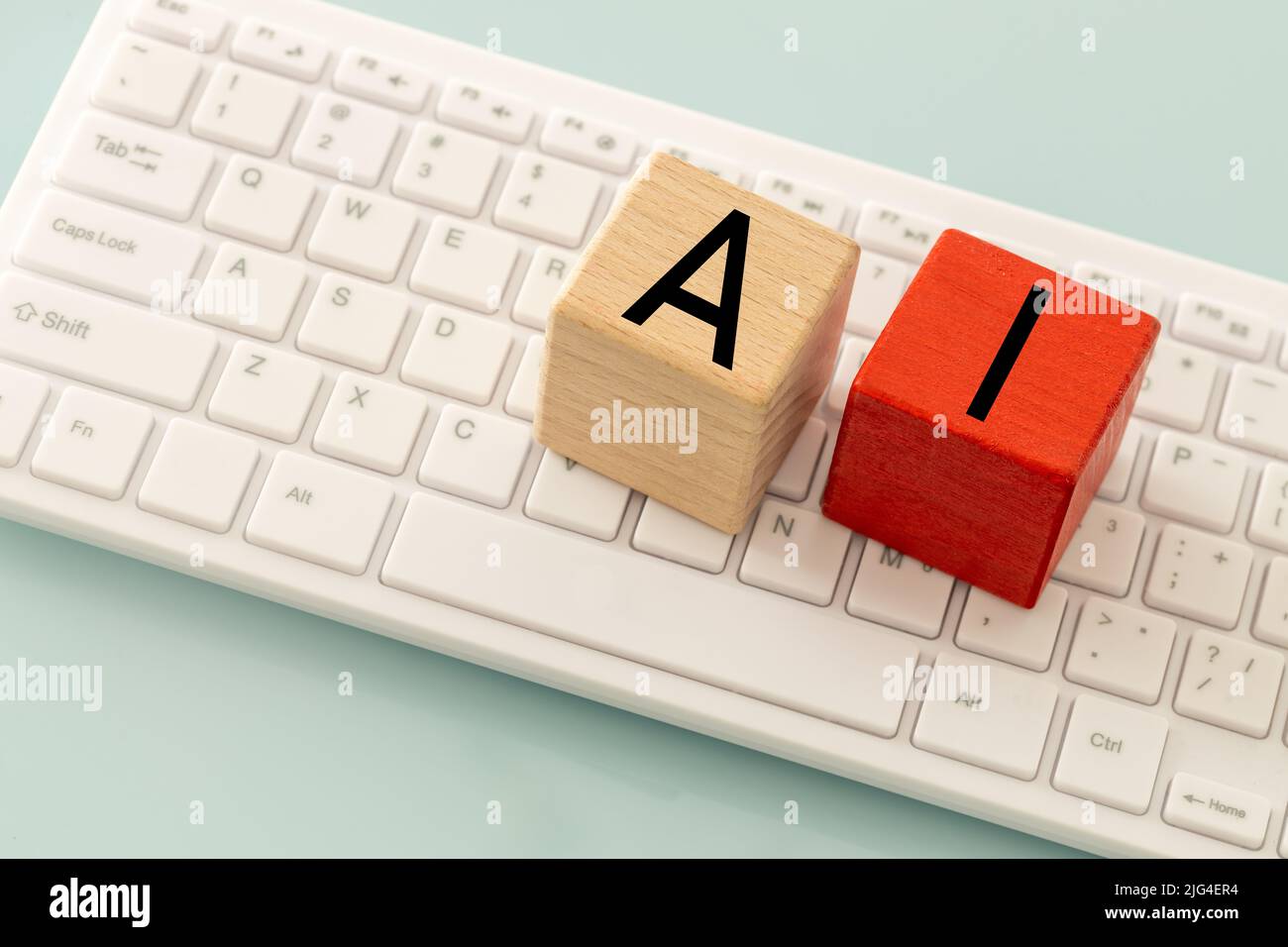 The word AI, artificial intelligence on wooden blocks and a computer ...