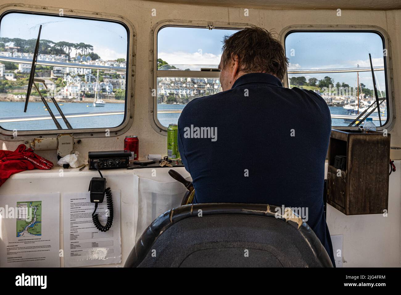 The ferryman. The Polruan passenger ferry which operates between Fowey ...