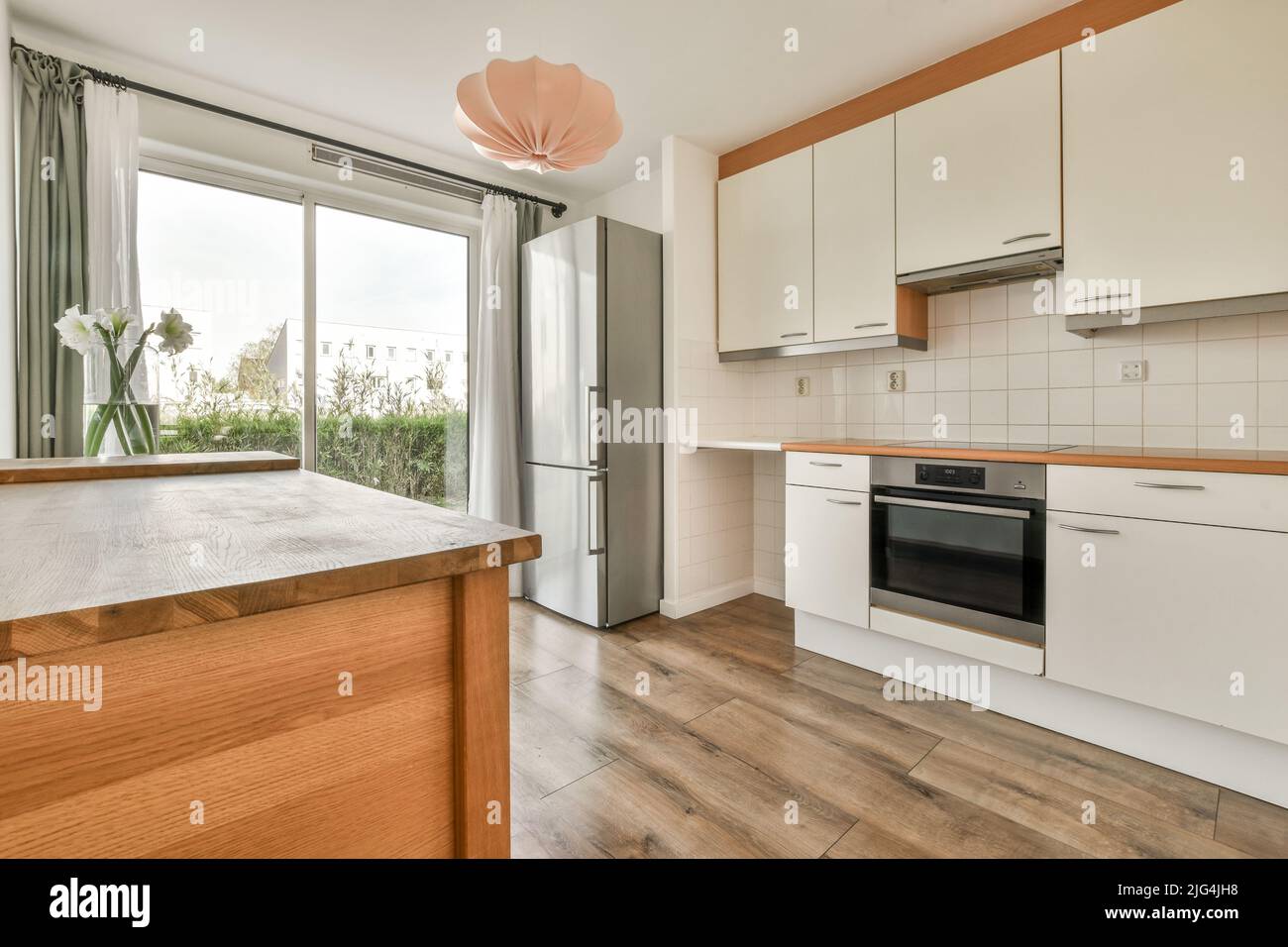 Fragment of interior of light narrow home kitchen with minimalist style ...