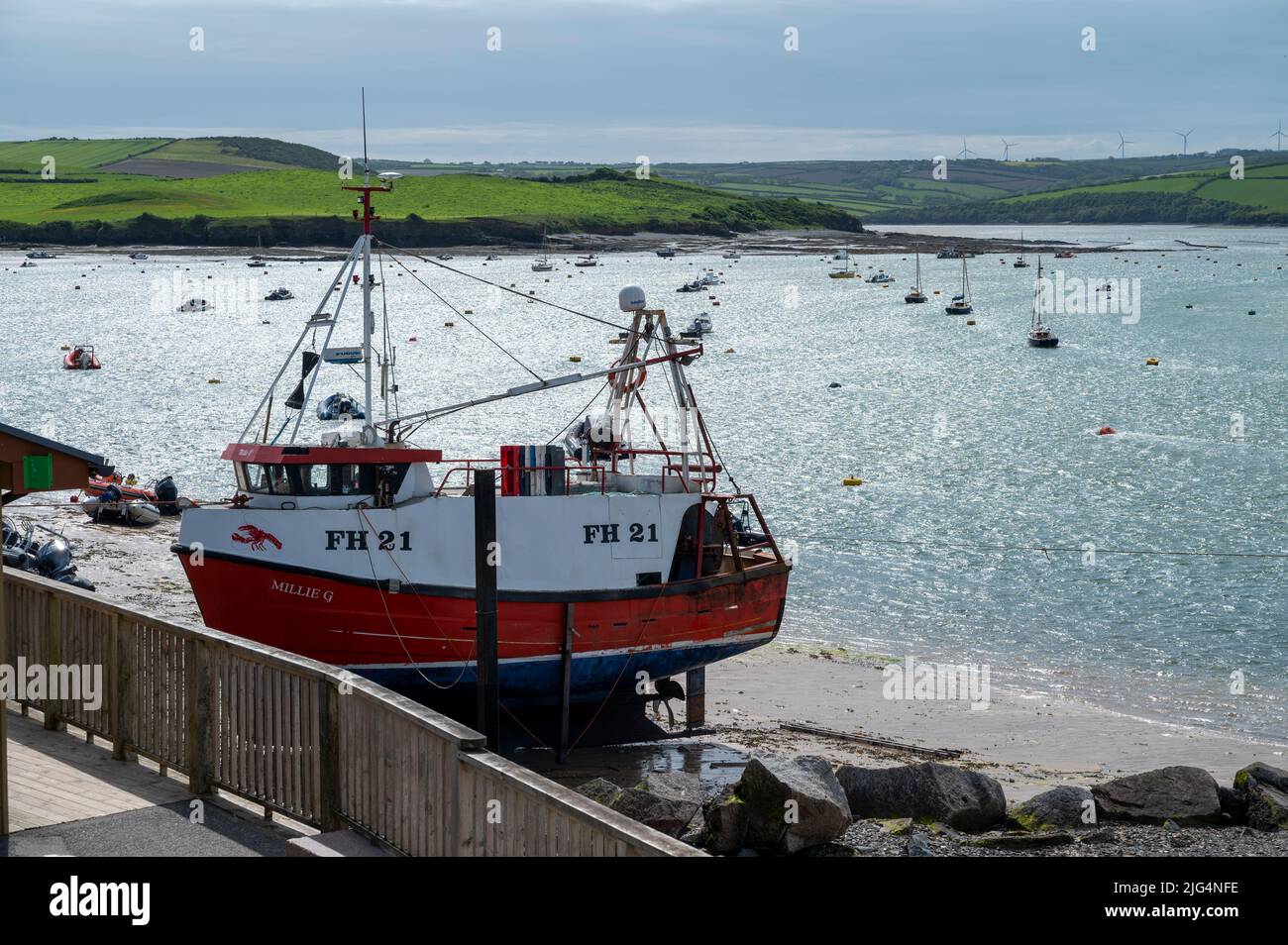 A fishing boat undergoes repairs on the beach at Rock with The Camel ...