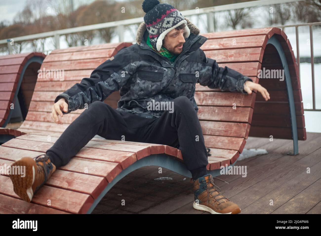 Guy abruptly gets up from bench. Man rises from seat. Man in park ...