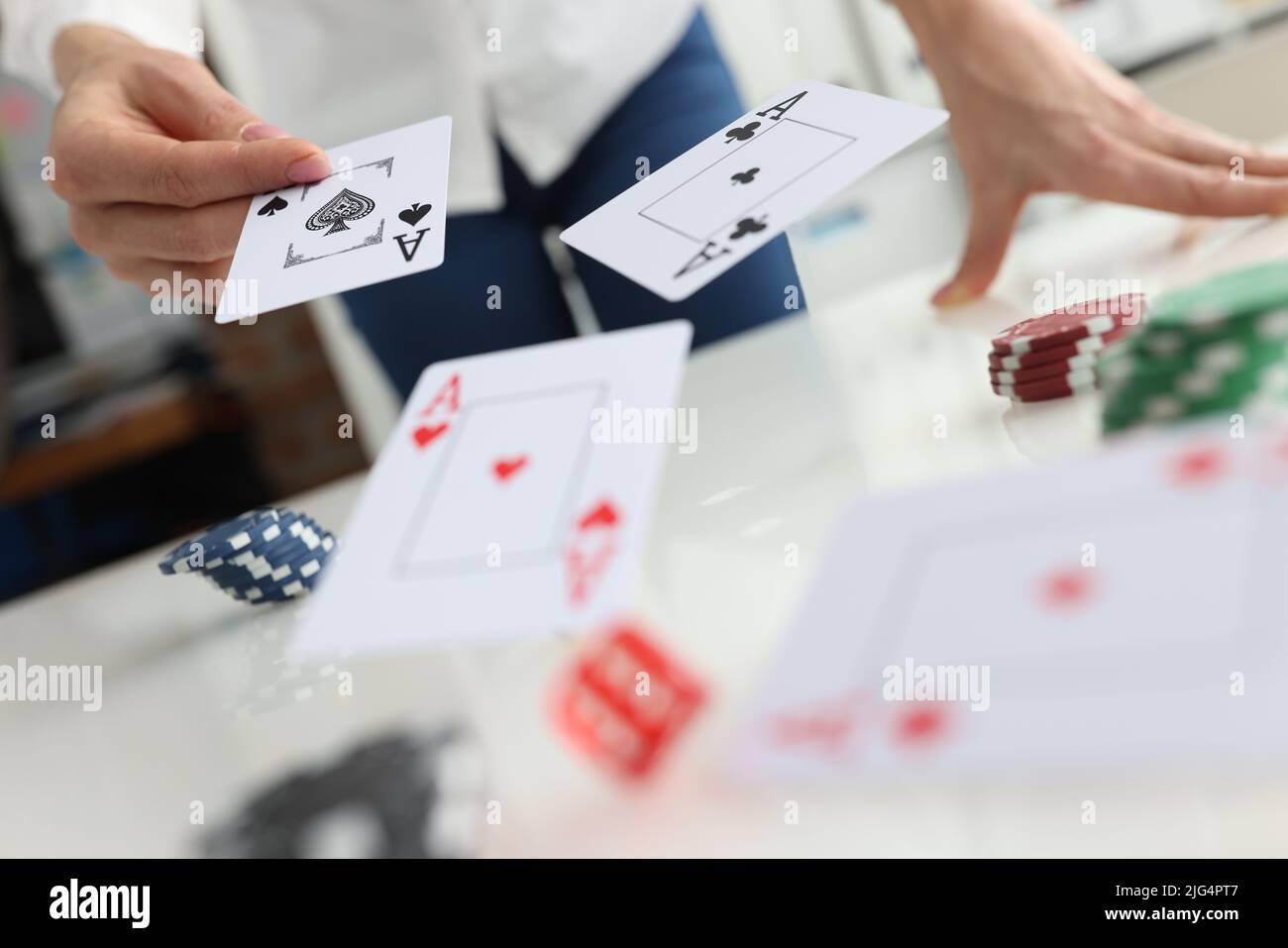 Person throws playing cards on table closeup Stock Photo - Alamy