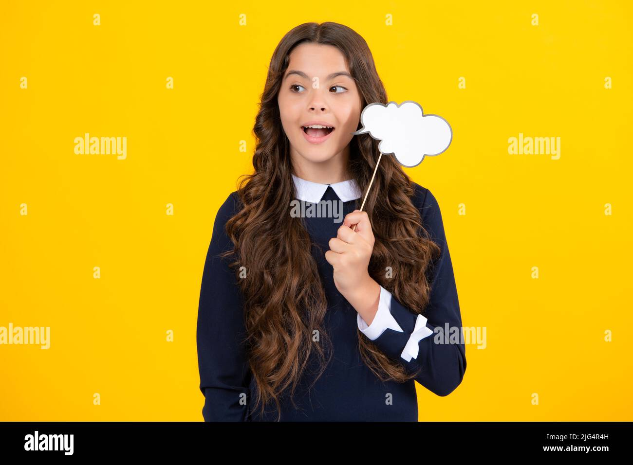 Teen girl holding thinking bubble, comment cloud over yellow background ...