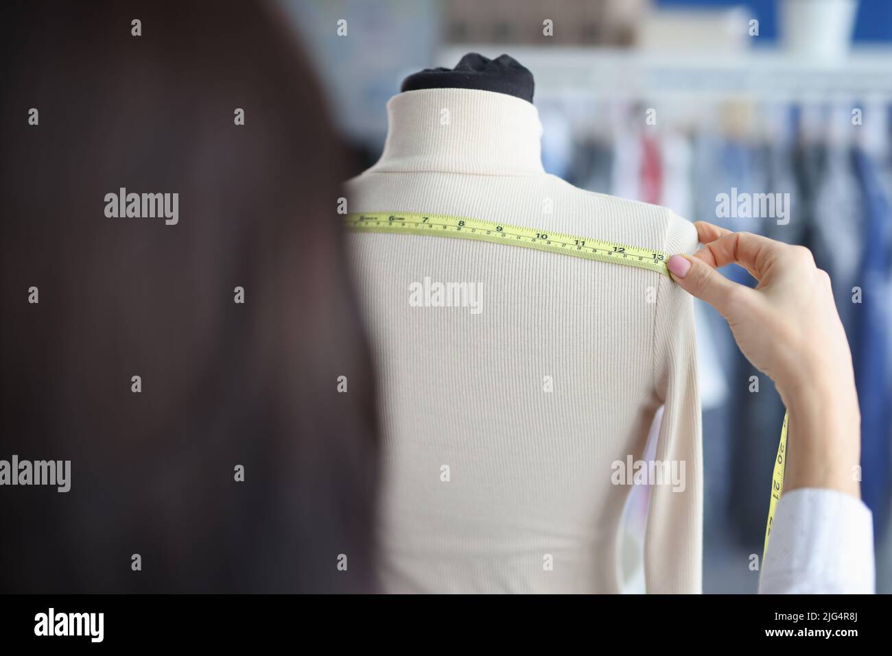 Fashion designer stylist takes measurements with centimeter from ...