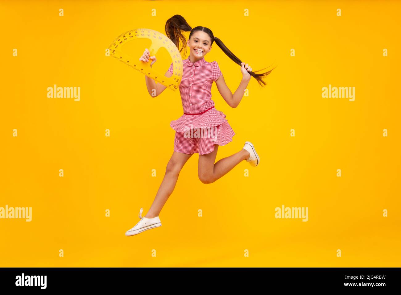 Measuring school equipment. Schoolgirl holding measure for geometry ...