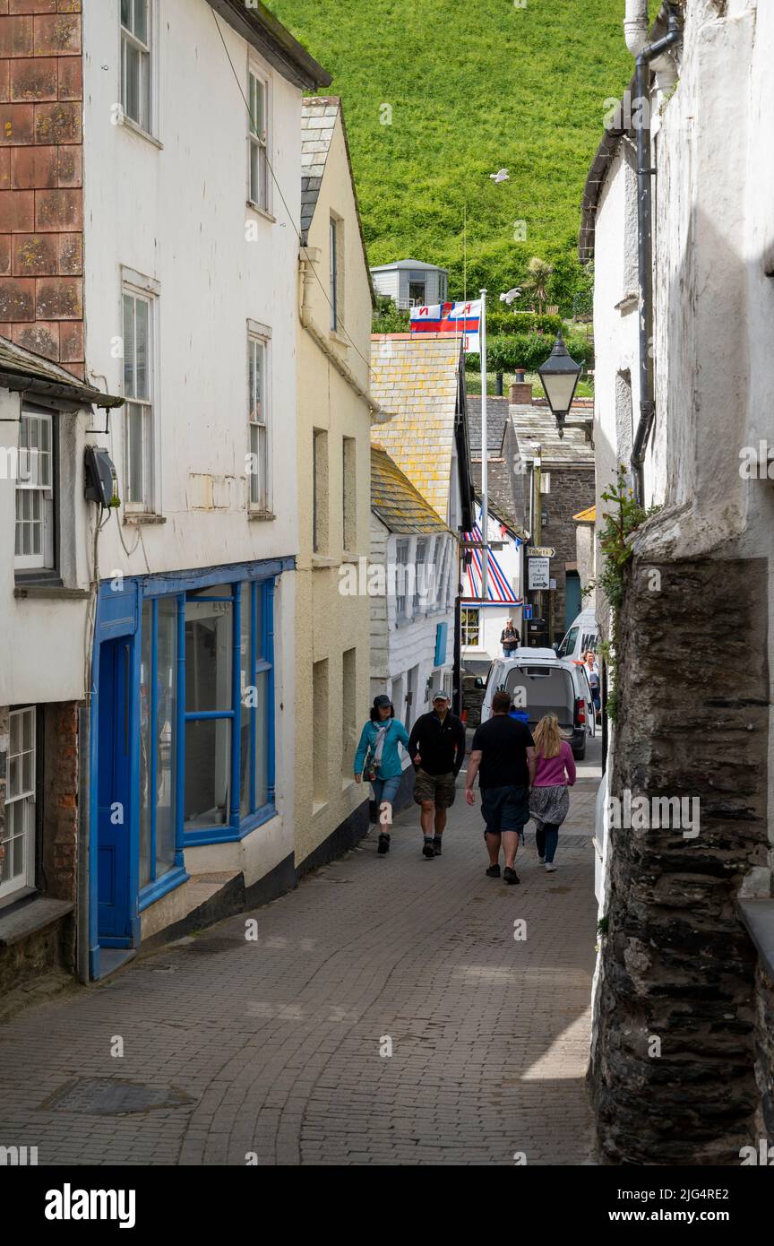 Holiday makers stroll amongst the narrow streets of the pretty coastal ...