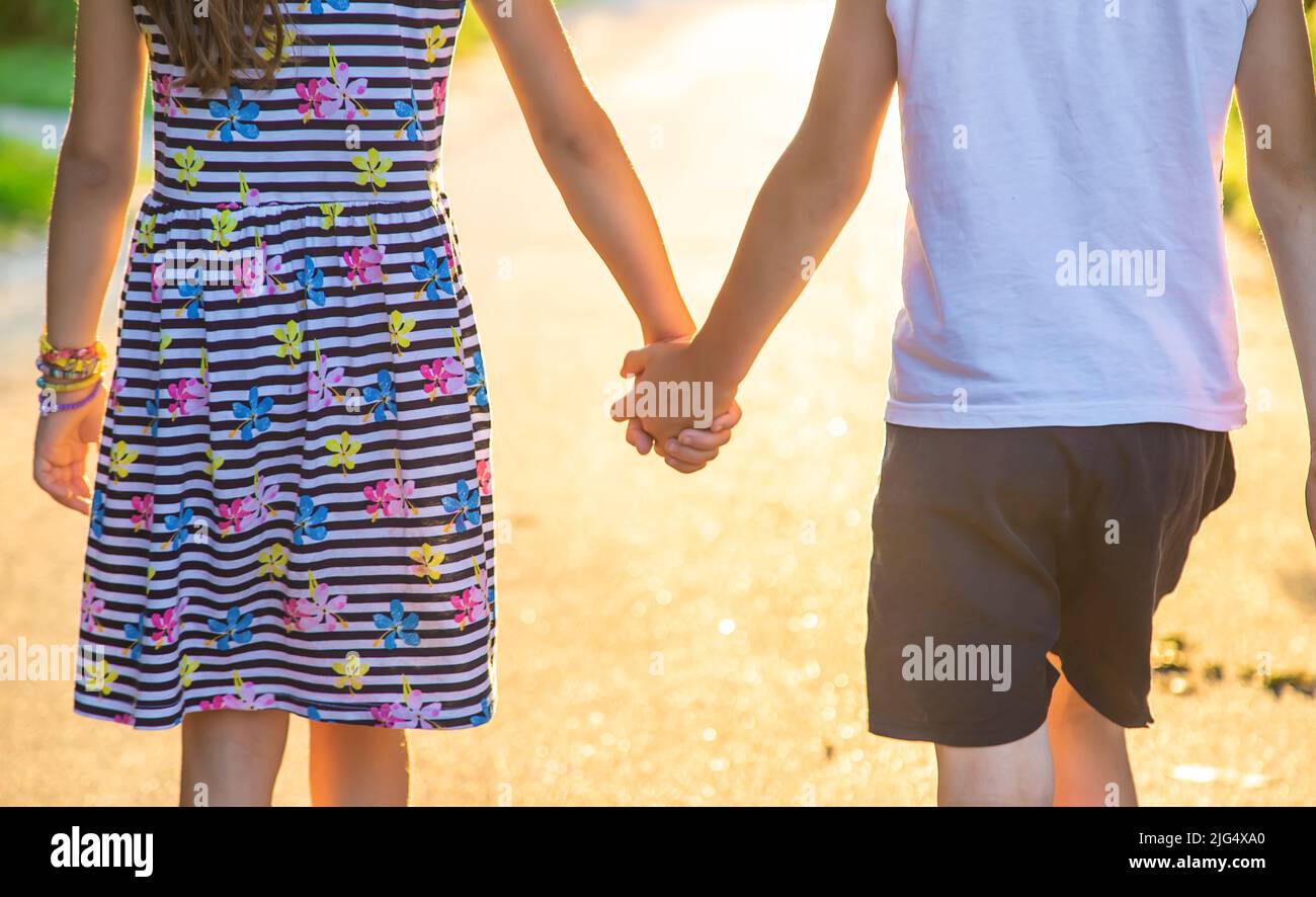 Children walk hand in hand. Selective focus. Kids Stock Photo - Alamy