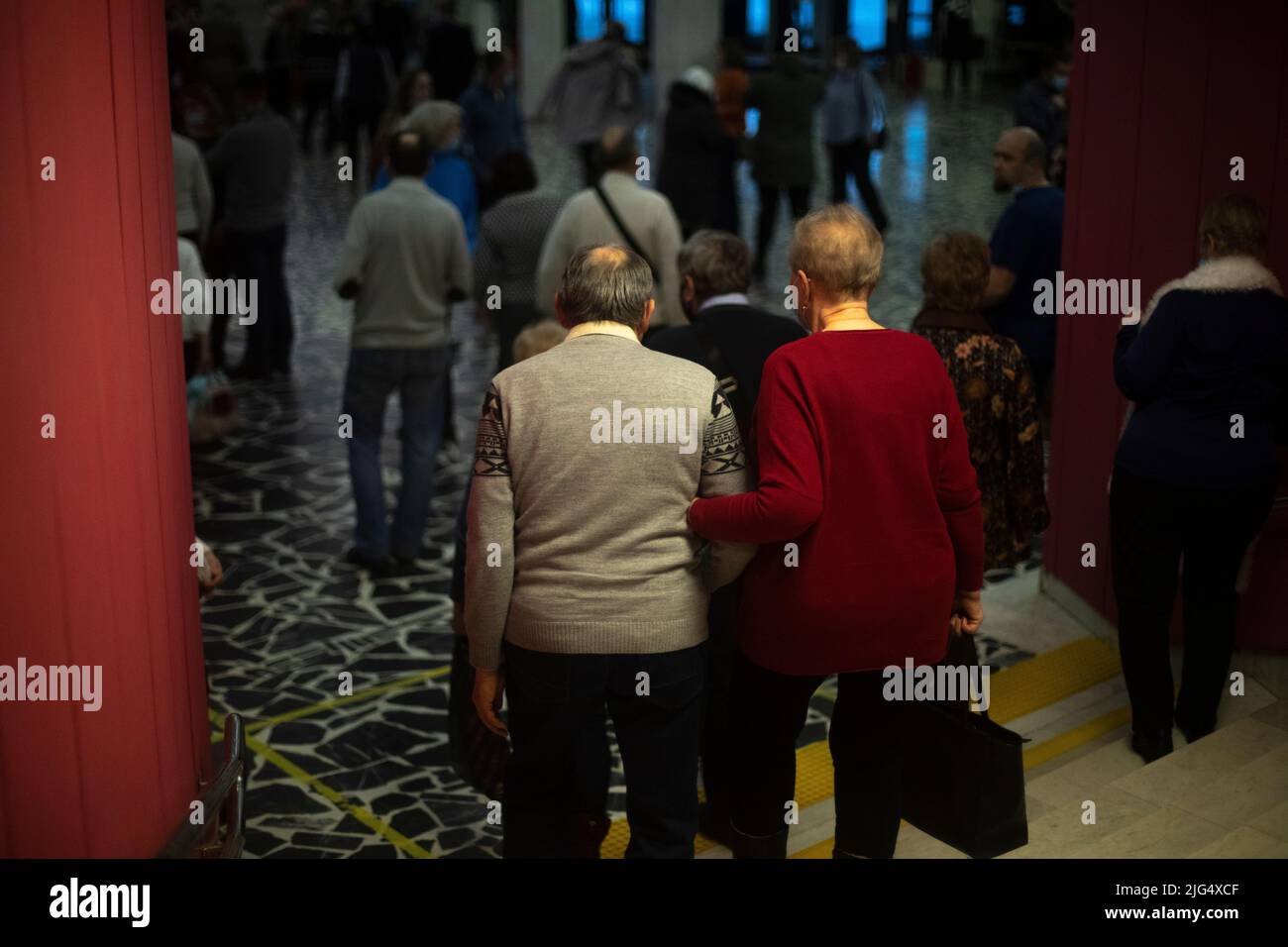 Elderly people leave hall. Old people go to meet veterans. People of ...
