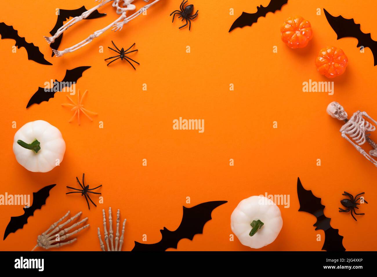 Orange Halloween background. Flock of black bats, spider, pumpkin ...