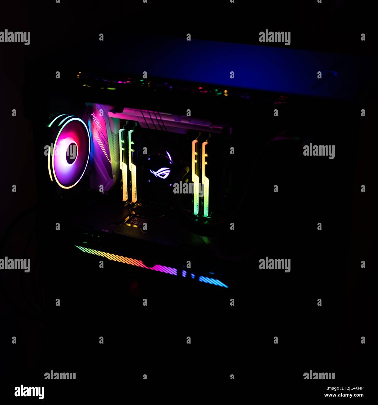 A high end gaming computer is illuminated with rainbow colors. All ...