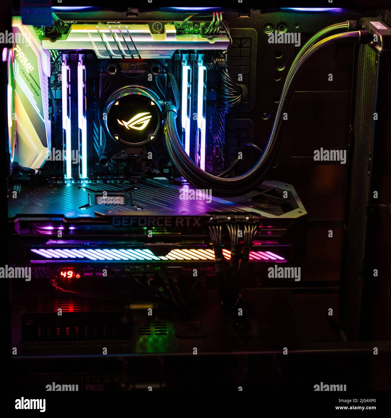 A high end gaming computer is illuminated with rainbow colors. All ...