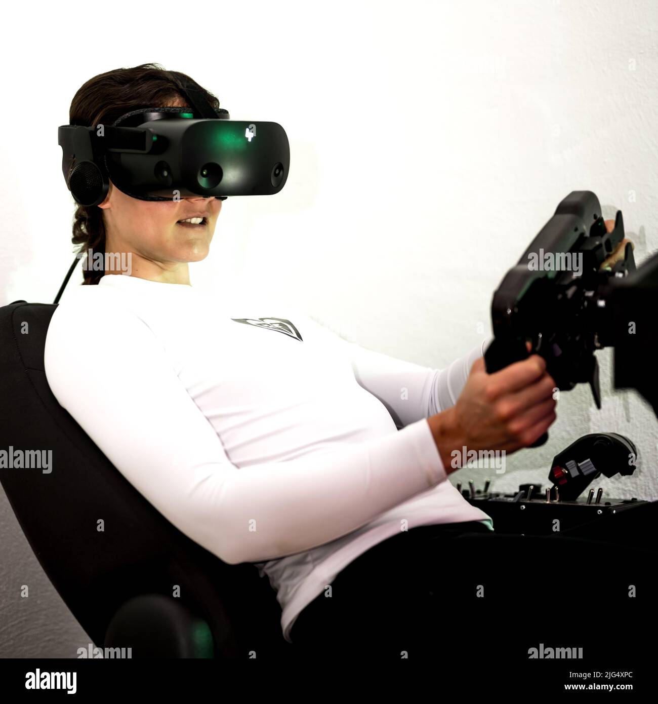 A gamer woman is sim racing with a high end simracing reck Stock Photo ...
