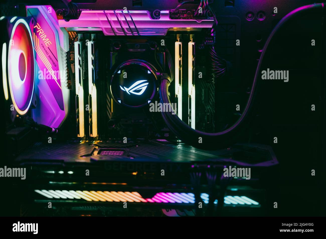 A high end gaming computer is illuminated with rainbow colors. All ...