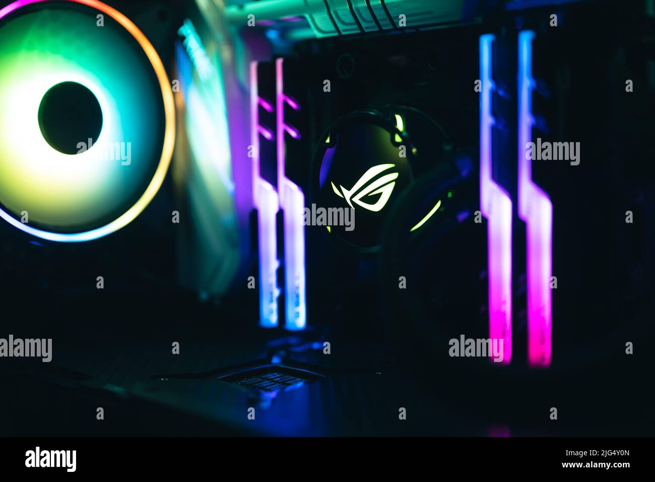 A high end gaming computer is illuminated with rainbow colors. All ...