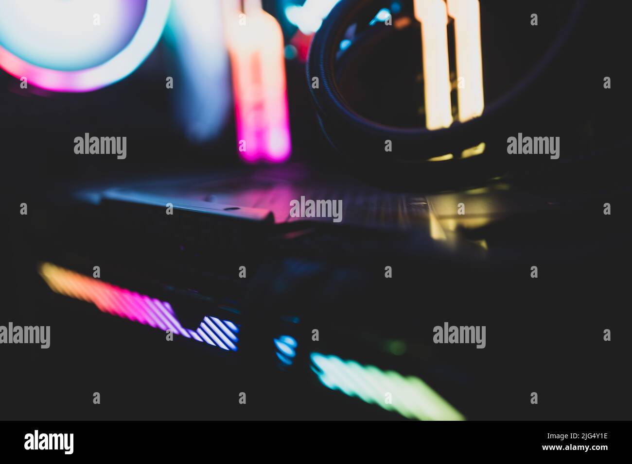 A high end gaming computer is illuminated with rainbow colors. All ...