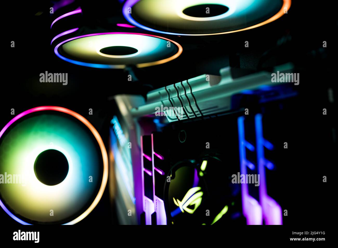 A high end gaming computer is illuminated with rainbow colors. All ...