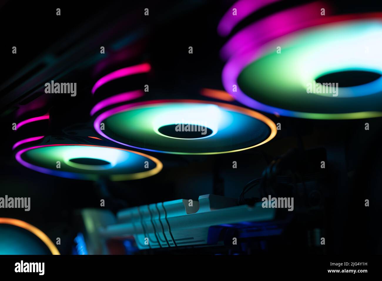 A high end gaming computer is illuminated with rainbow colors. All ...