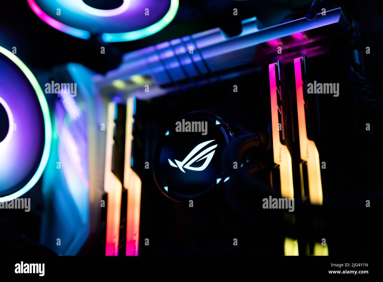 A high end gaming computer is illuminated with rainbow colors. All ...