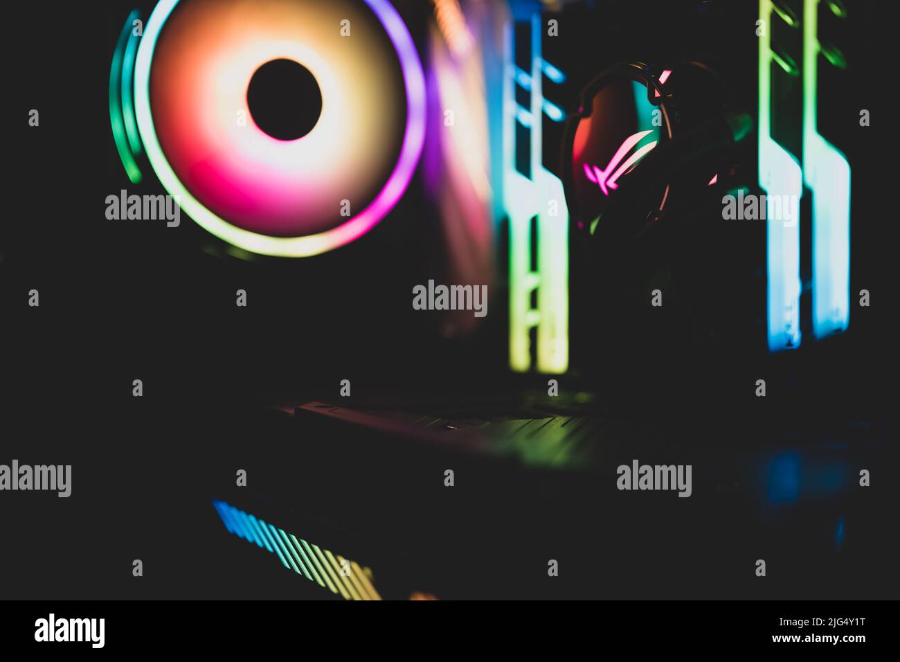 A high end gaming computer is illuminated with rainbow colors. All ...