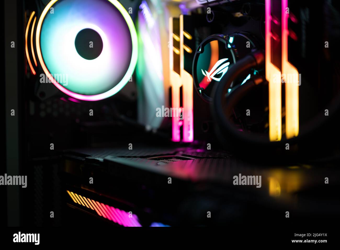 A high end gaming computer is illuminated with rainbow colors. All ...