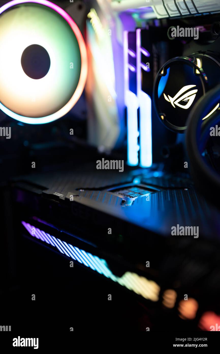 A high end gaming computer is illuminated with rainbow colors. All ...