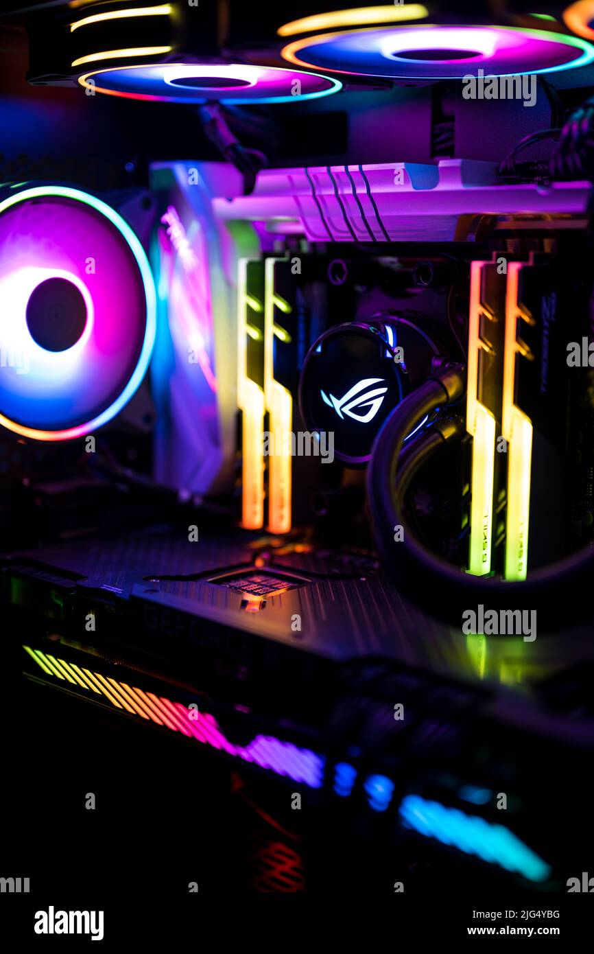 A high end gaming computer is illuminated with rainbow colors. All ...