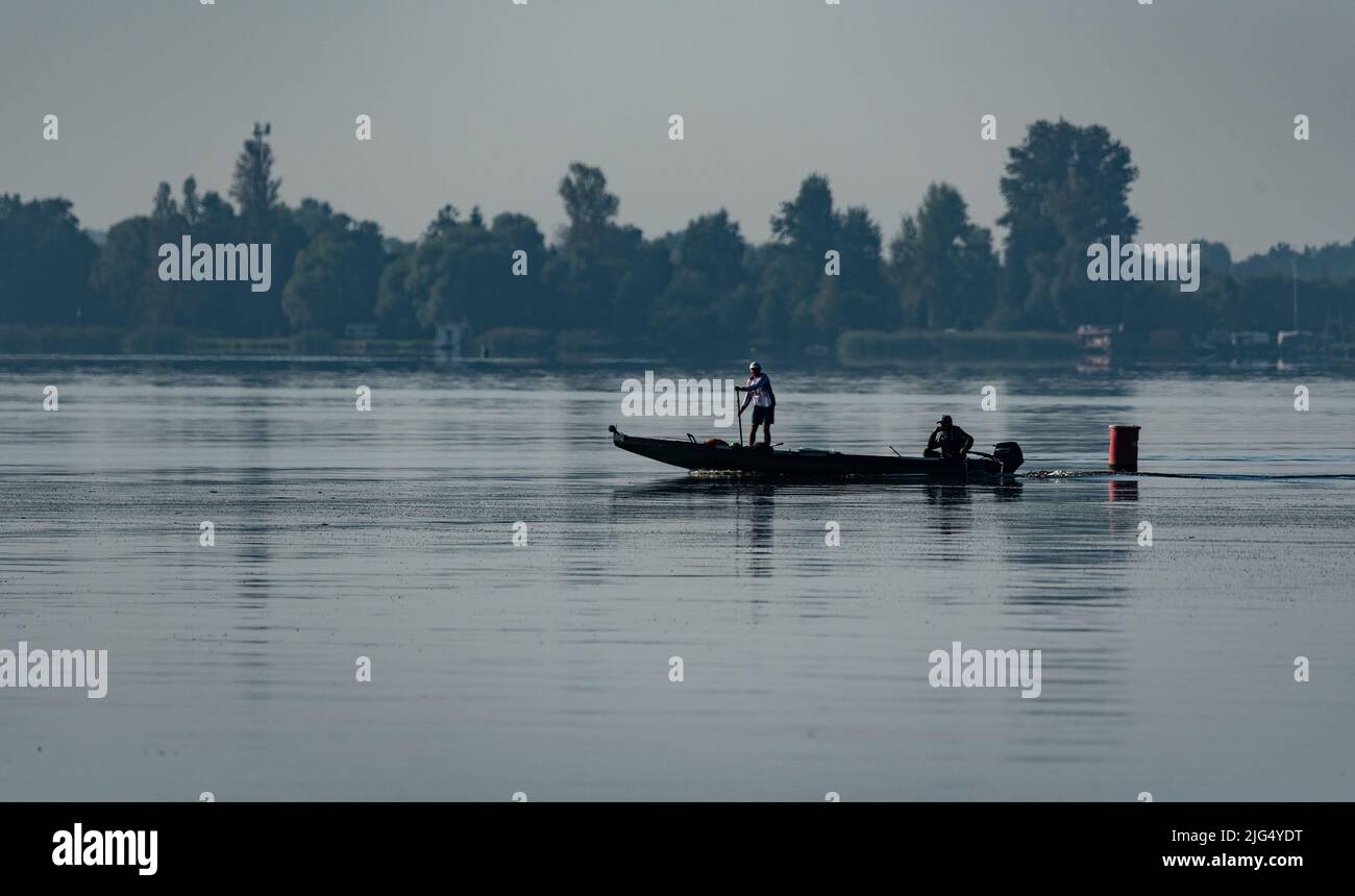 Zegrze, Poland - September 8, 2021: Angler in a boat with an internal ...