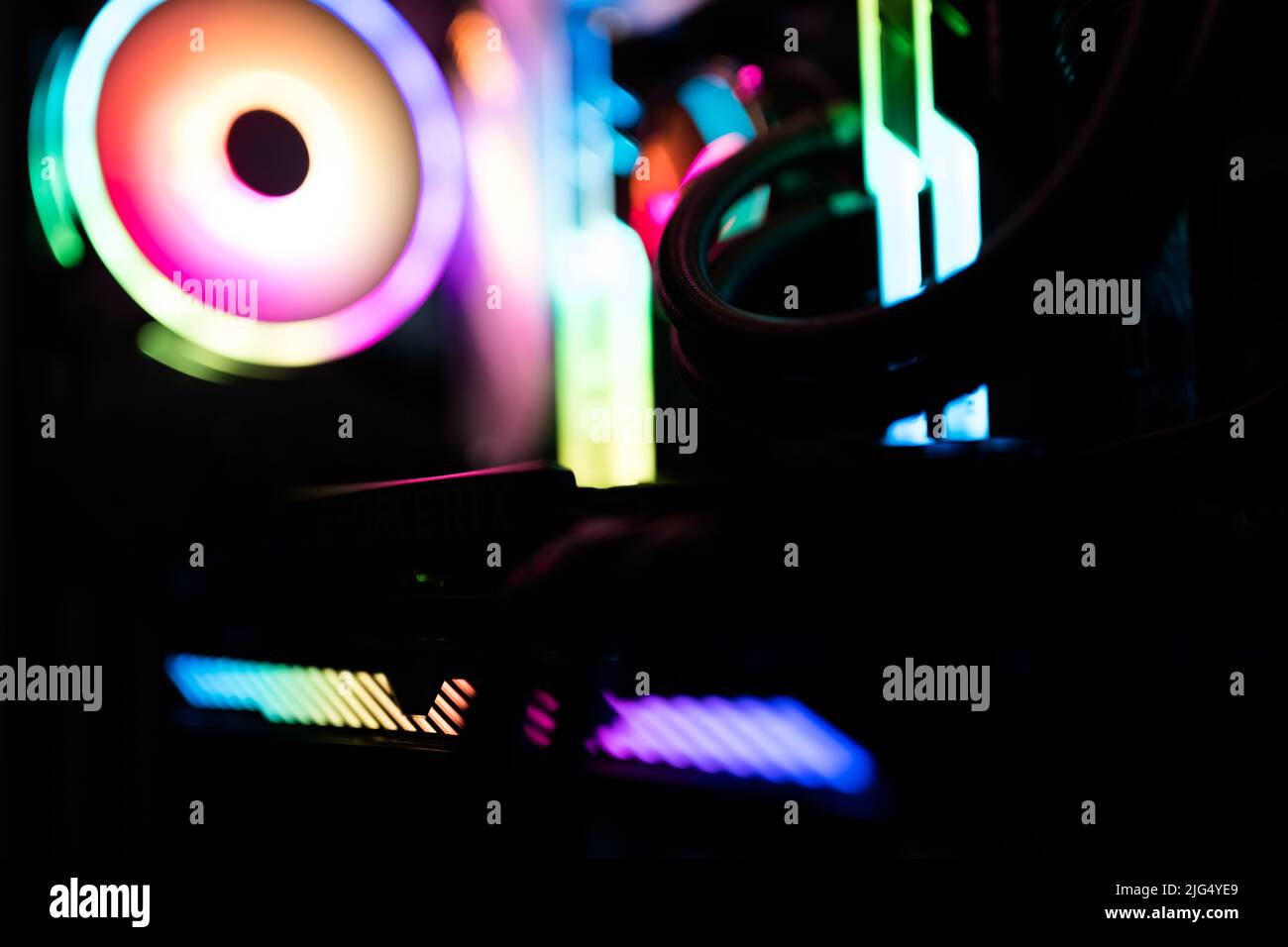 A high end gaming computer is illuminated with rainbow colors. All ...