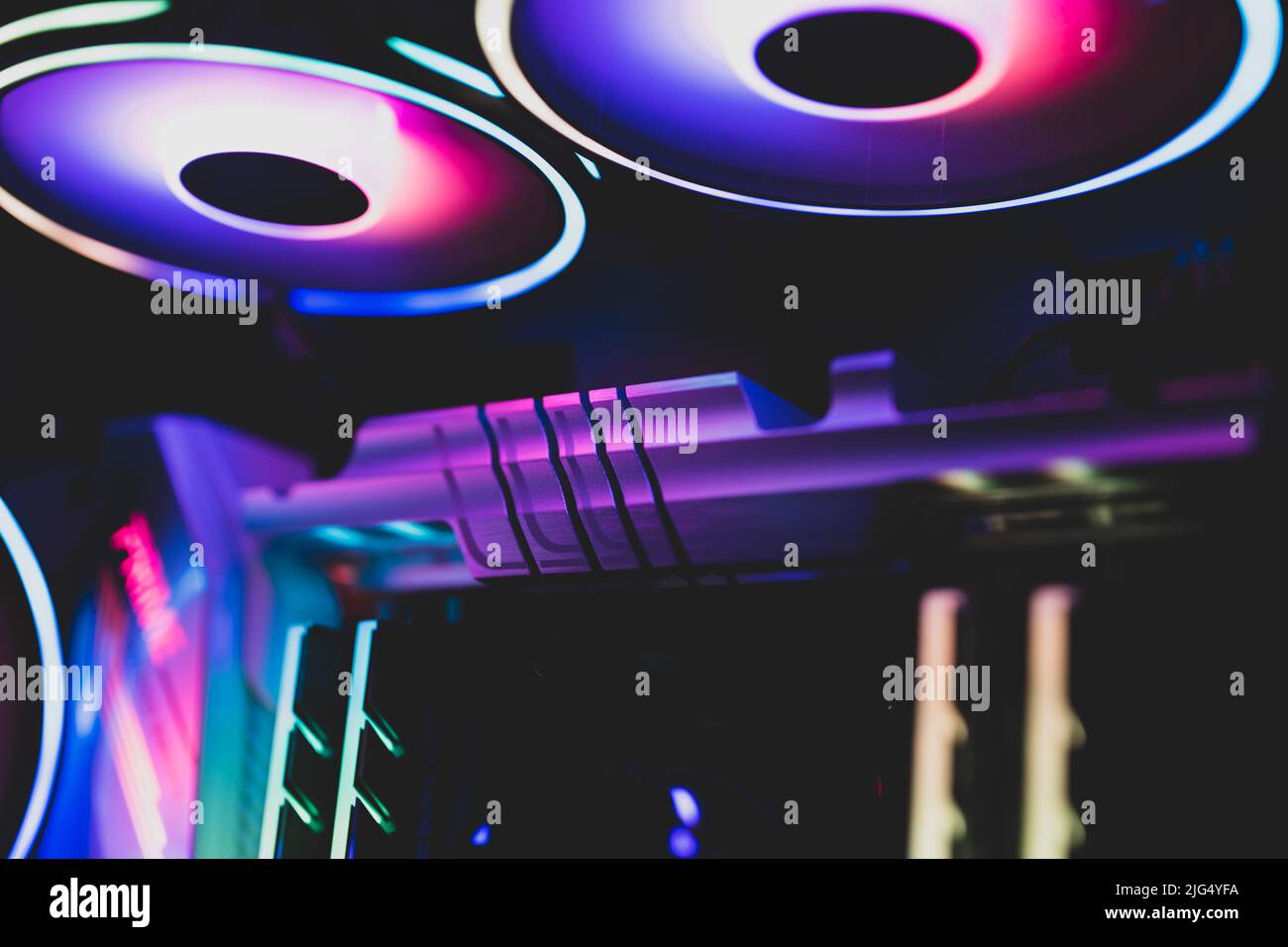 A high end gaming computer is illuminated with rainbow colors. All ...