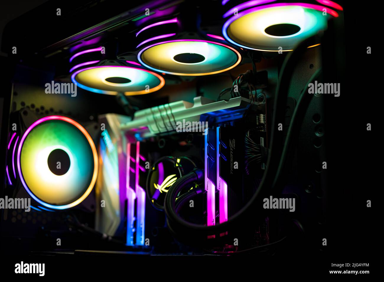 A high end gaming computer is illuminated with rainbow colors. All ...