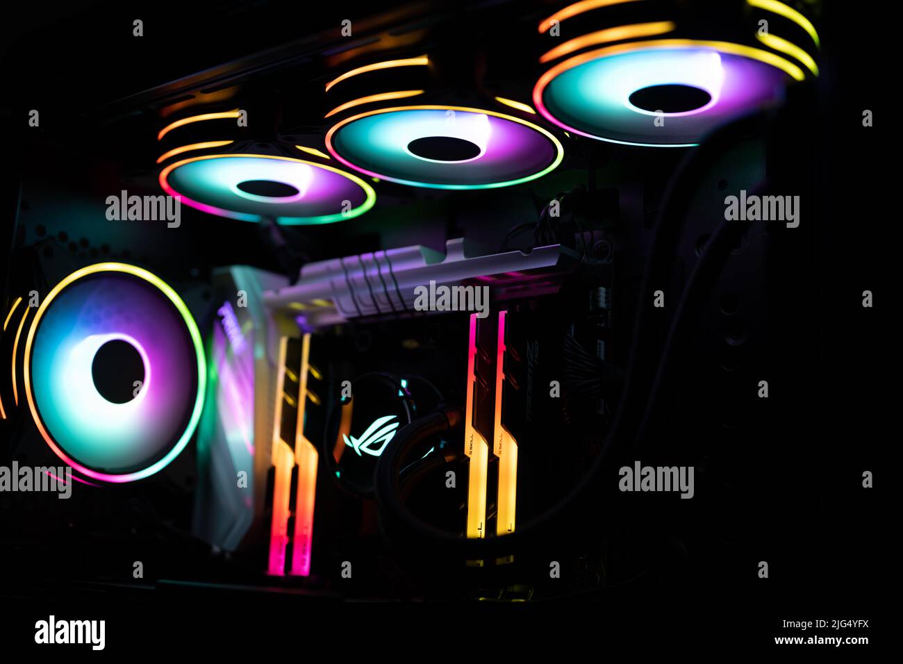 A high end gaming computer is illuminated with rainbow colors. All ...
