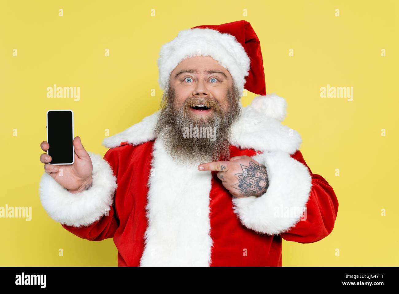 excited overweight santa claus pointing at cellphone with blank screen ...