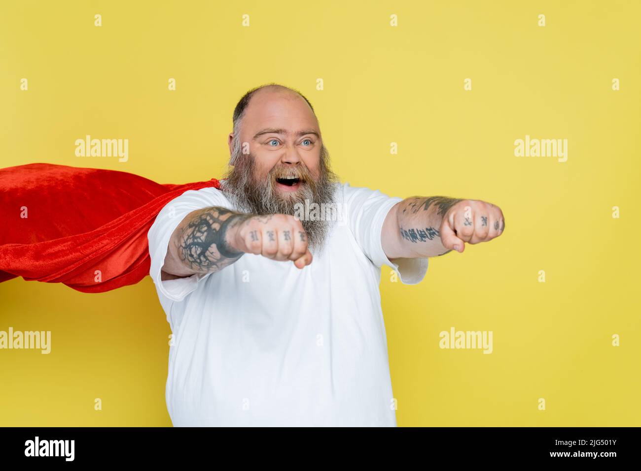 bearded overweight man in superhero costume shouting with outstretched ...