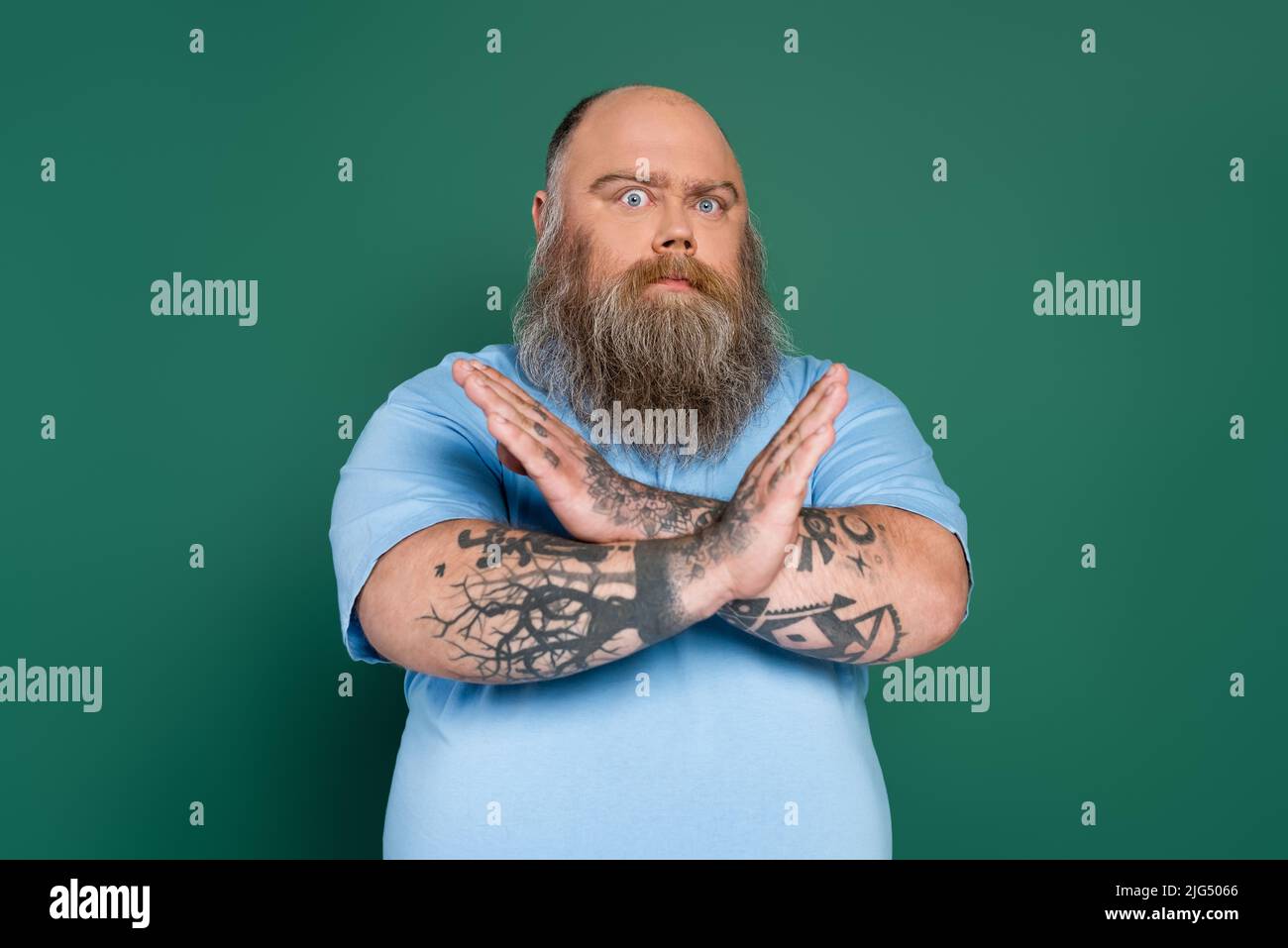 tense plus size man showing refuse gesture with crossed arms isolated ...