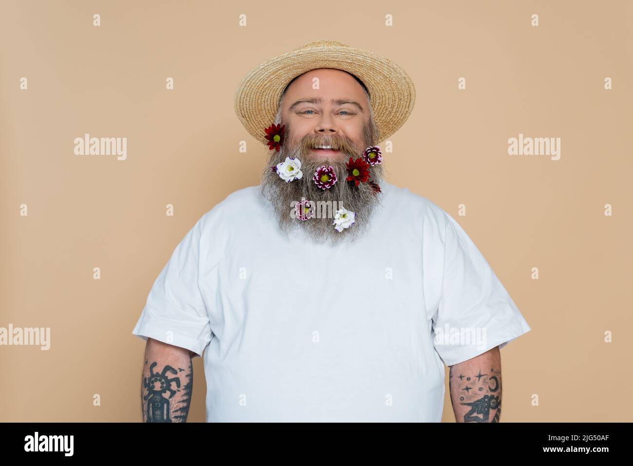 overweight man with decorated beard and straw hat smiling at camera ...