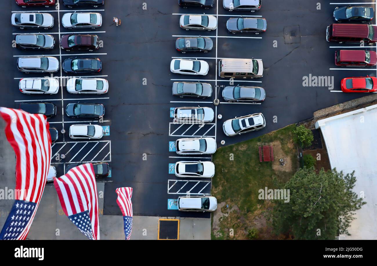 American flags from balconies over a filled parking lot Stock Photo - Alamy