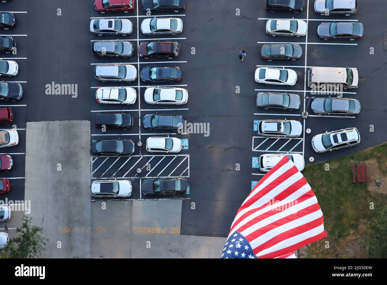 American flag from balconies over a filled parking lot Stock Photo - Alamy