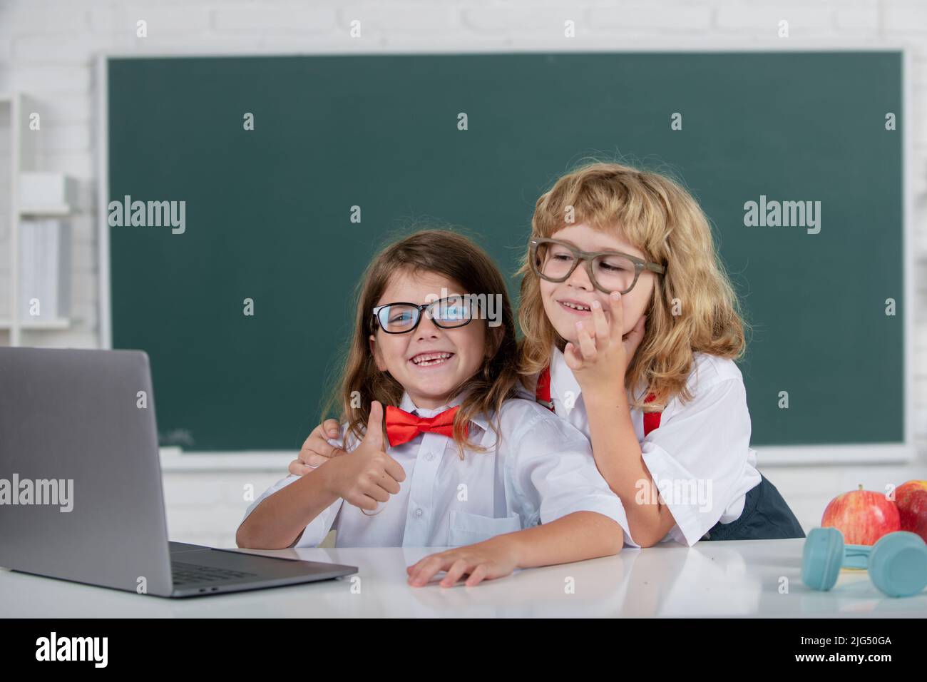 School friends. Friendly classmates in school uniform at lesson. Boy ...