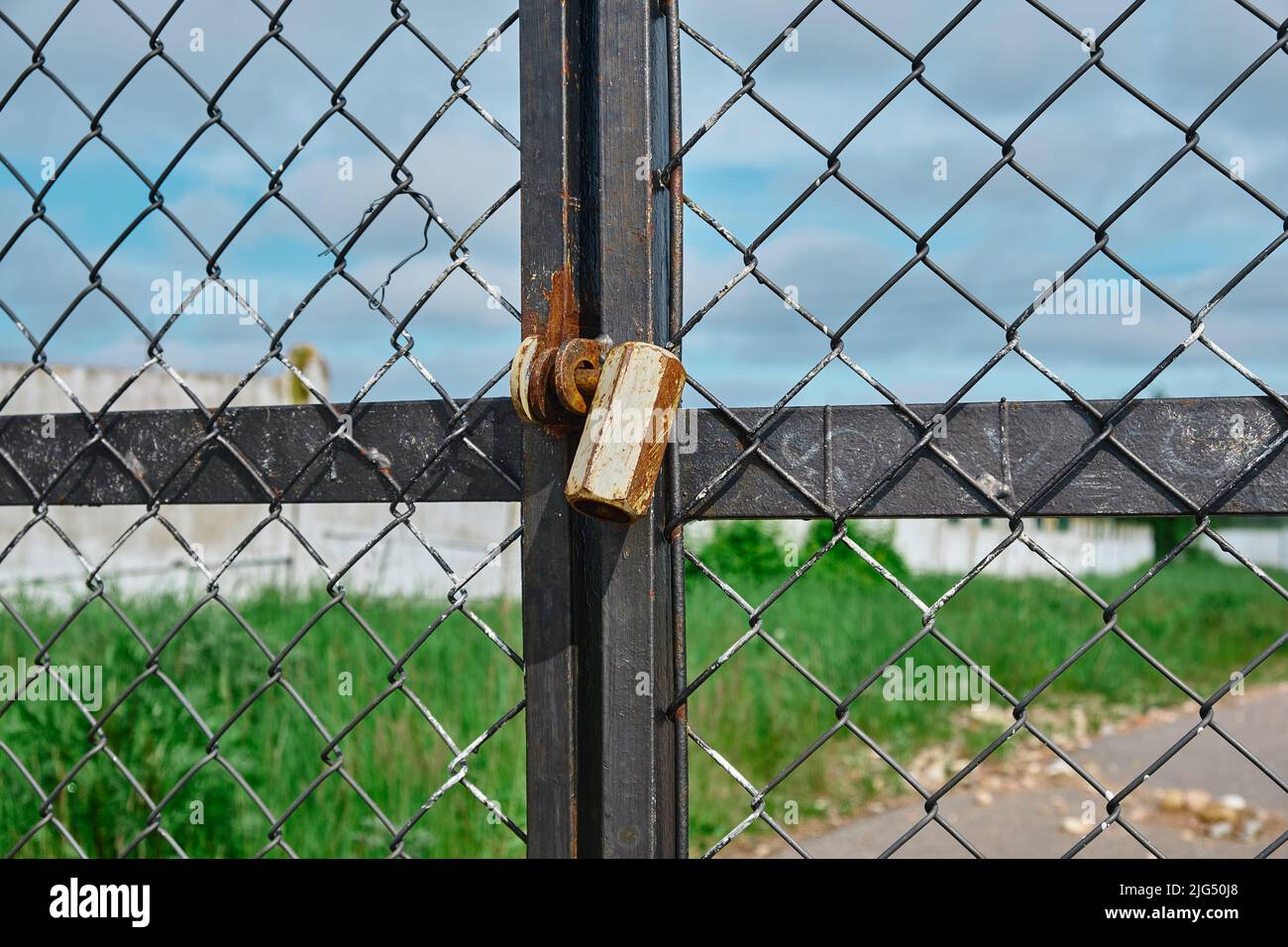 Brass padlock was locked with wire mesh door Stock Photo - Alamy