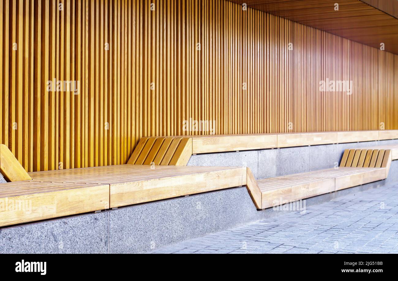 Empty modern wooden benches without people on a sunny day, public ...