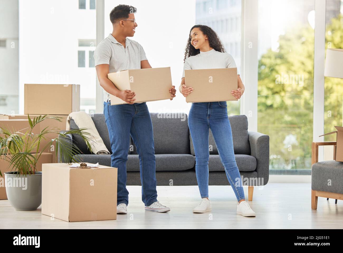 Its time for the move. Shot of a young couple moving into their new ...