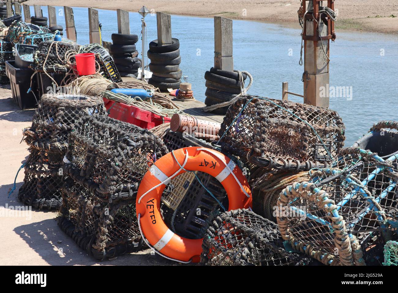 Lobster pots and other various pieces of fishing equipment piled up by ...