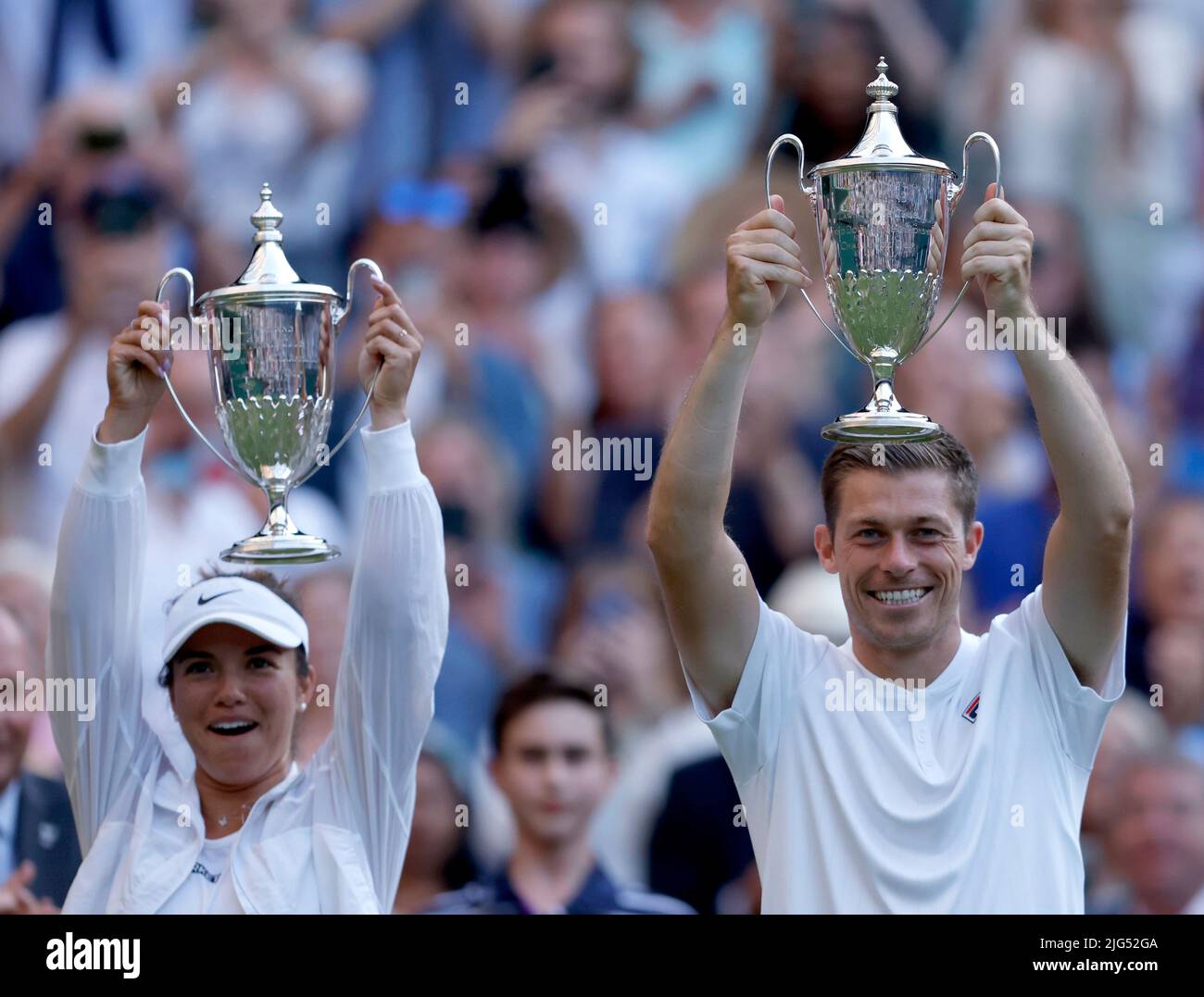 Neal Skupsk and Desirae Krawczyk celebrate with their trophies after ...