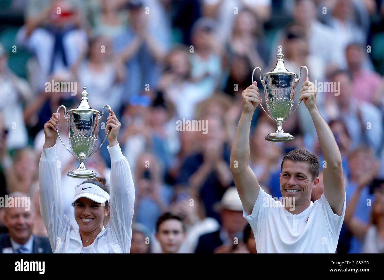 Neal Skupsk and Desirae Krawczyk celebrate with their trophies after ...
