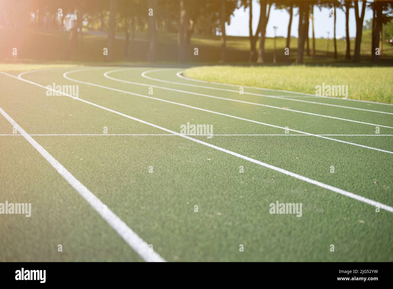 Running track at the stadium. Rubber coated green. Running track in the ...